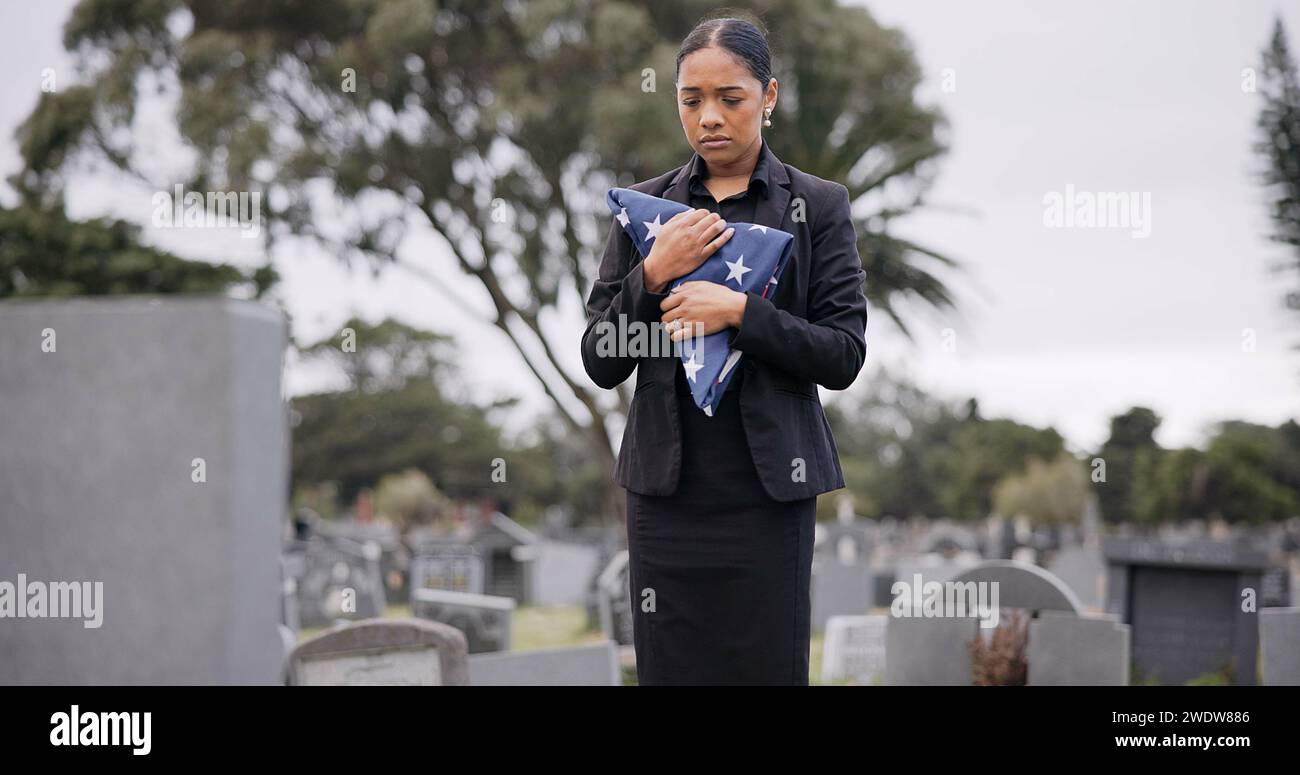 Funeral, death and a sad woman with an american flag at a cemetery in ...