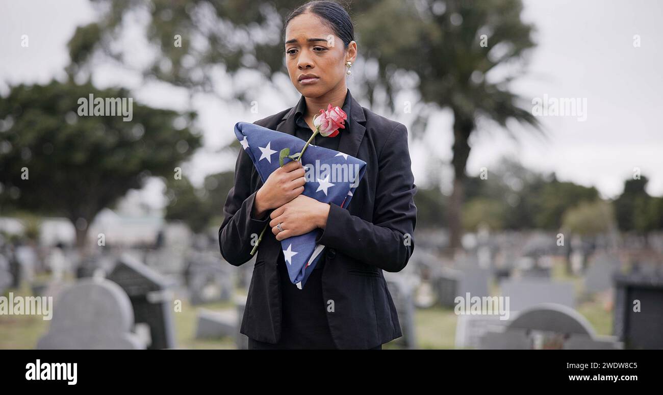 Funeral, rose and american flag with a woman at a cemetery in mourning ...