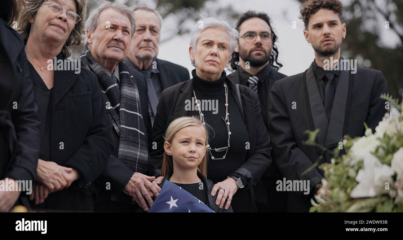 Funeral, cemetery and family with American flag for veteran for respect ...