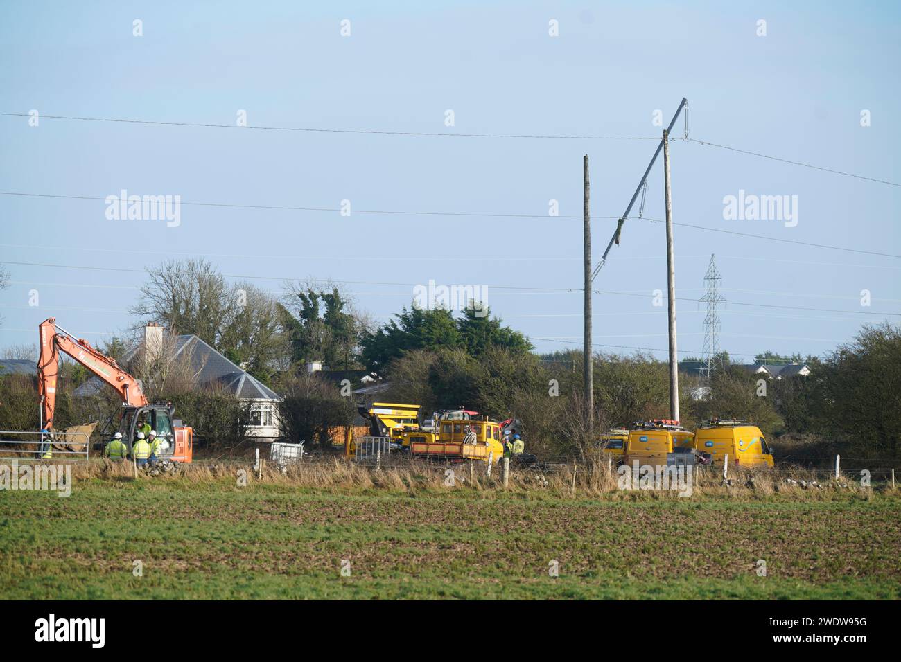 Crews from ESB Networks replace fallen electricity pylons in a field ...