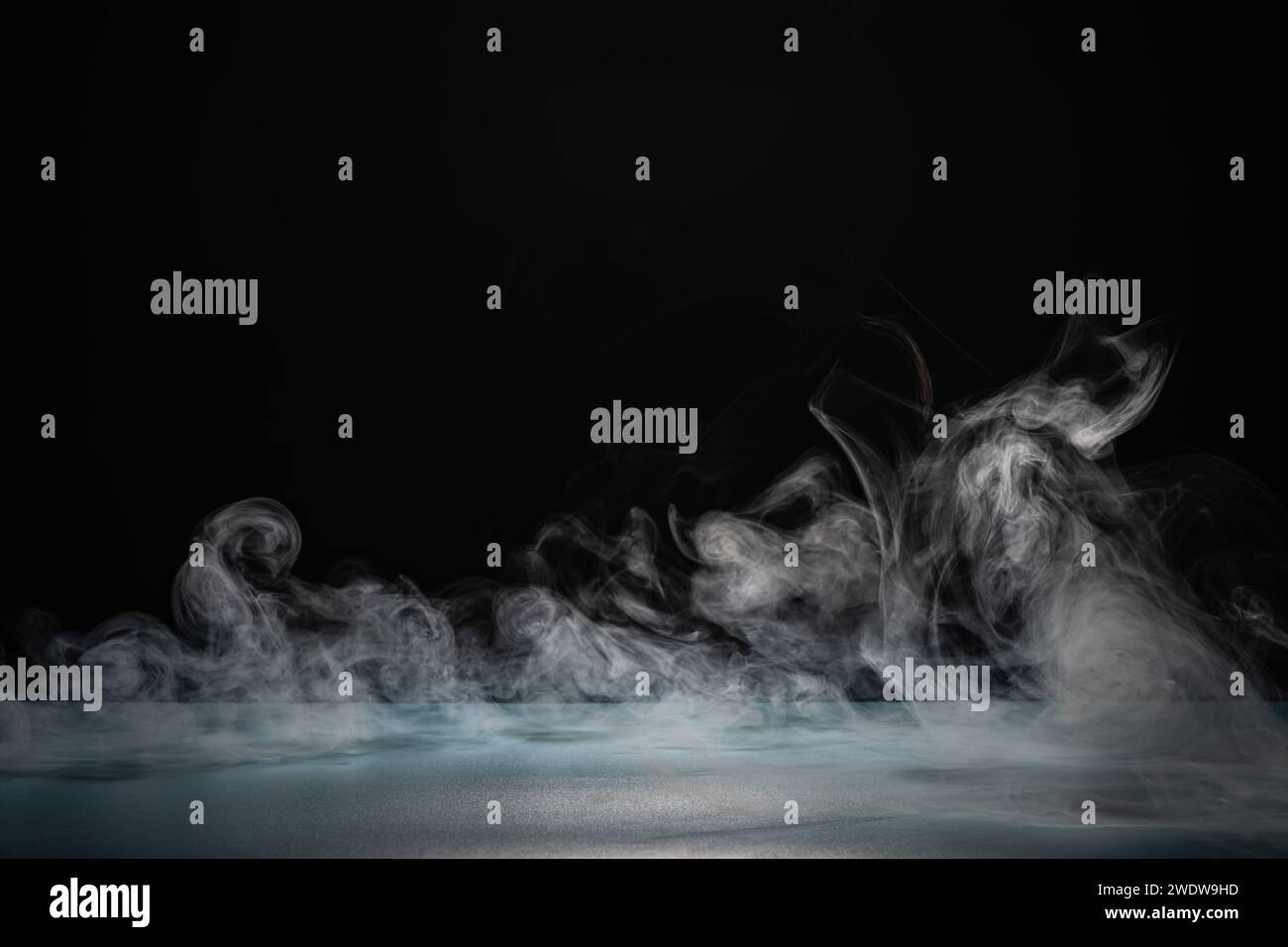 Swirling White Smoke Against a Dark Background in a Low-Light Studio ...
