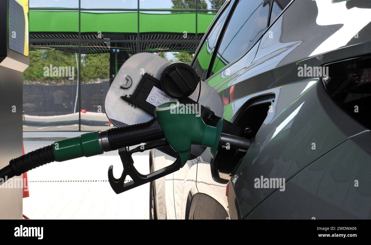 Refueling nozzle inserted into the car gas tank neck rear view Stock ...