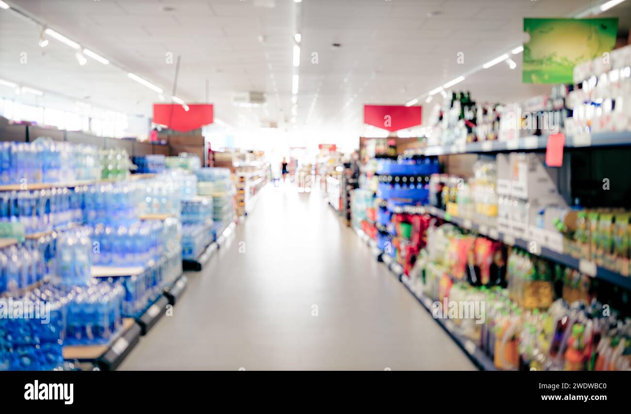Supermarket shelfs with variety drink bottles. Grocery store aisle with ...