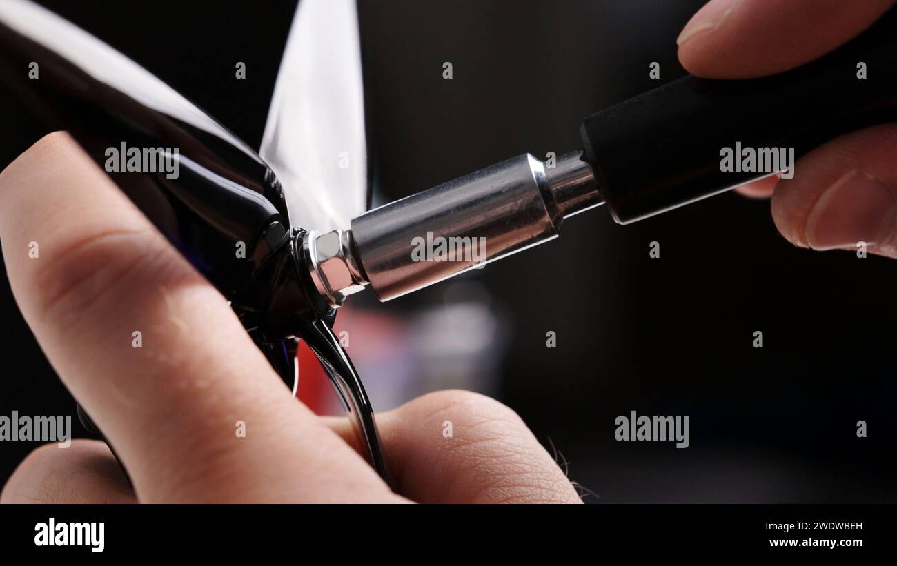 Assembling fpv DIY drone. Attaching a propeller and tightening ...