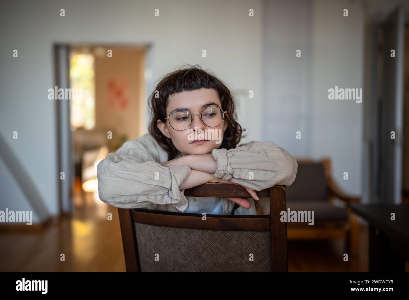 Emotional burnout of young boring woman sitting on chair in sorrow ...