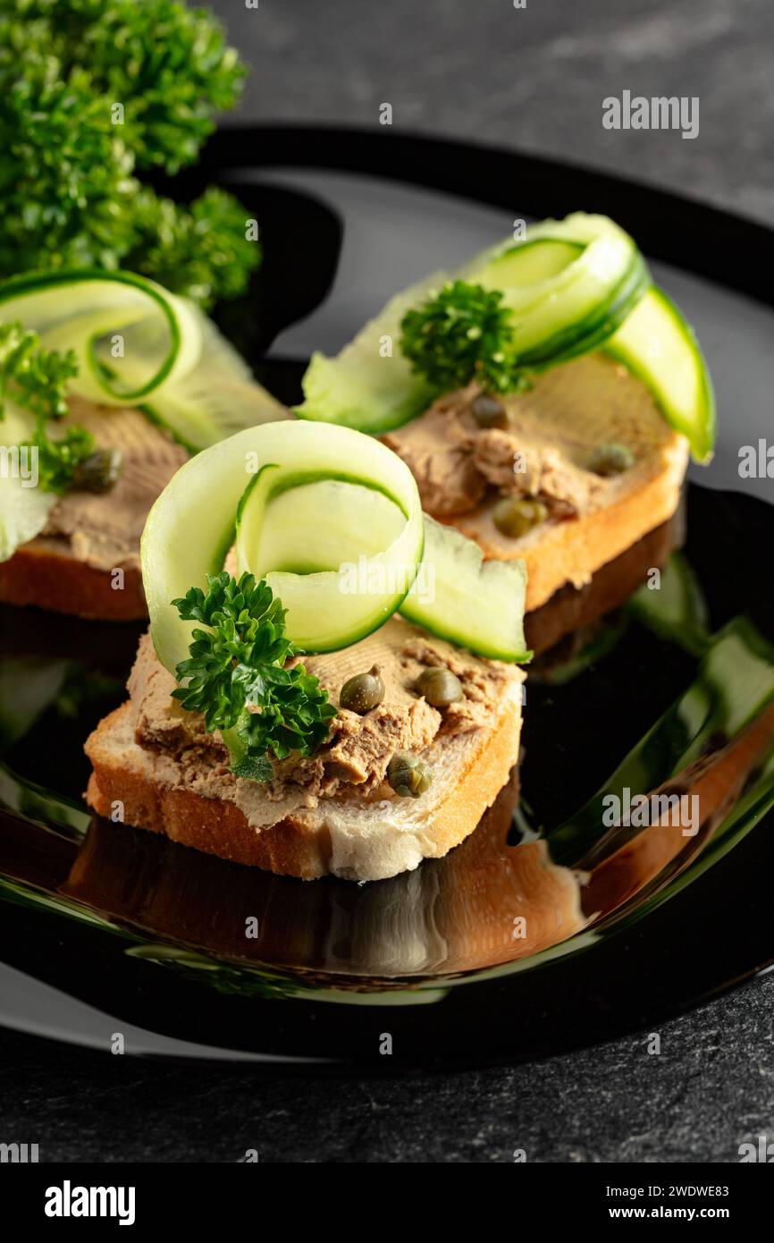 Open sandwiches with pate, fresh cucumber, capers, and parsley. Toasts ...