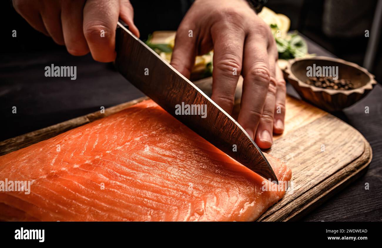 Cook cuts trout fish on hi-res stock photography and images - Alamy