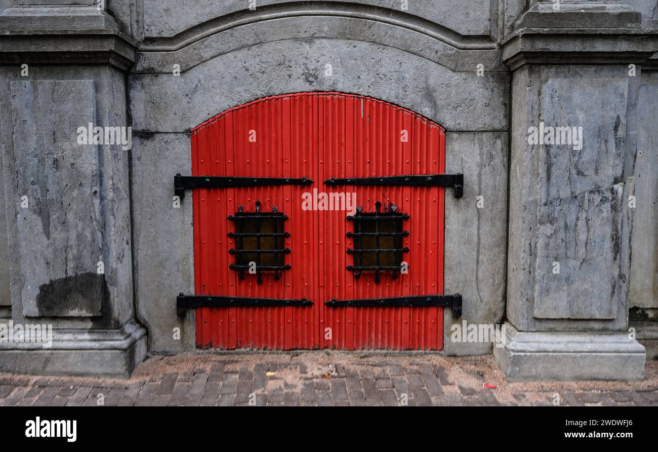 Traditional red door with design in stone building castle wall ...
