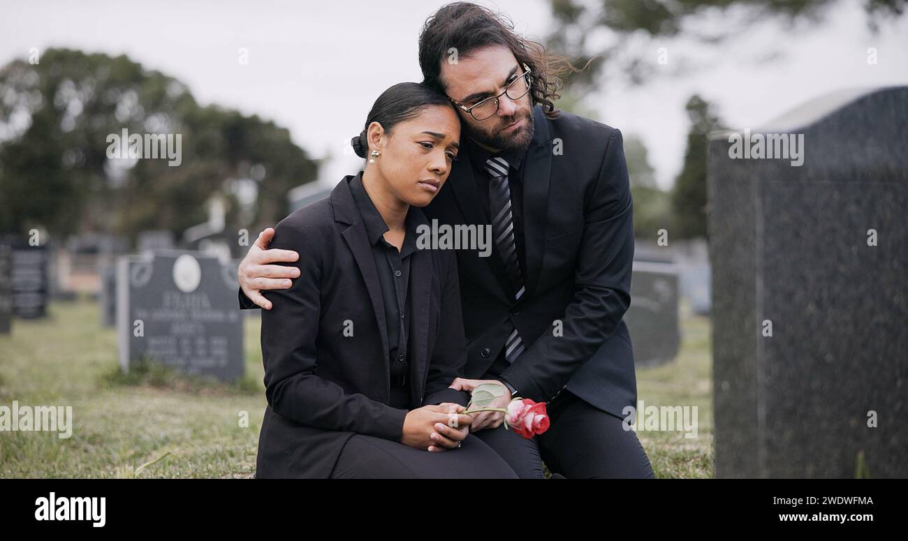 Sad couple, rose and graveyard in loss, grief or mourning at funeral ...