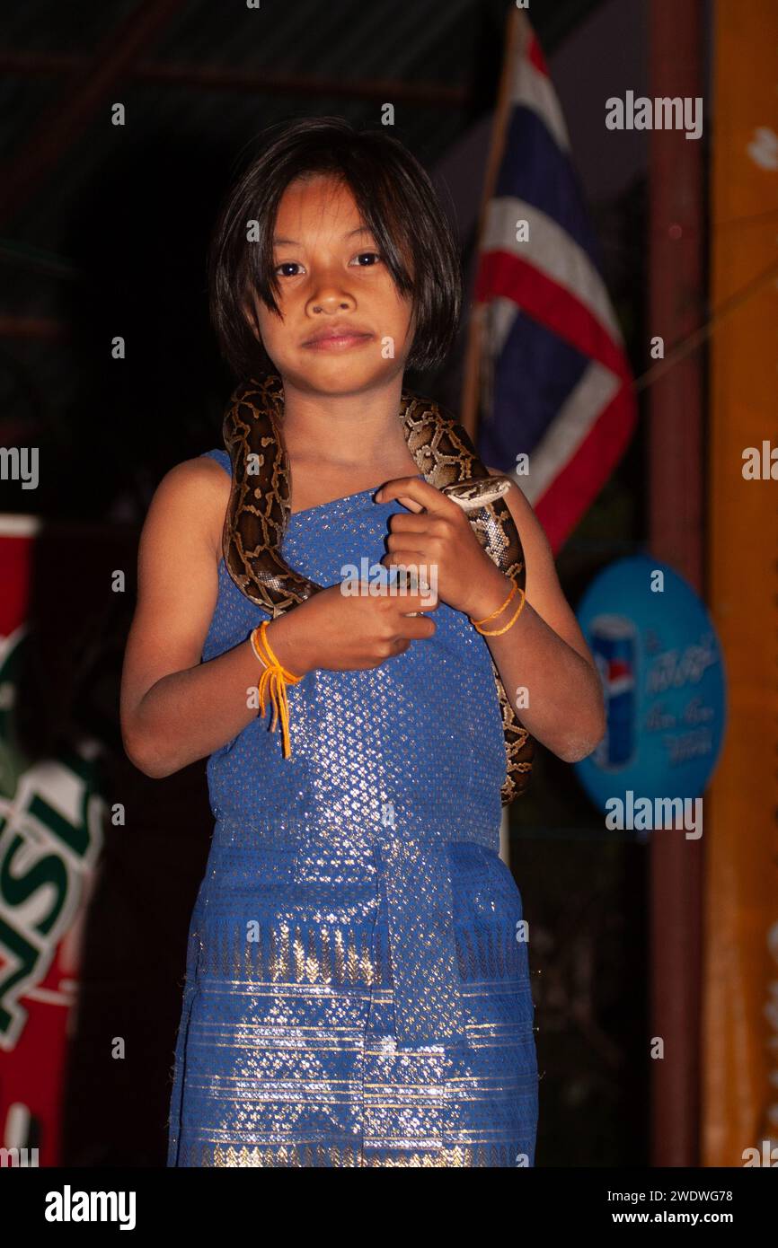 Young Thai girl with a python snake around her shoulders Photographed ...