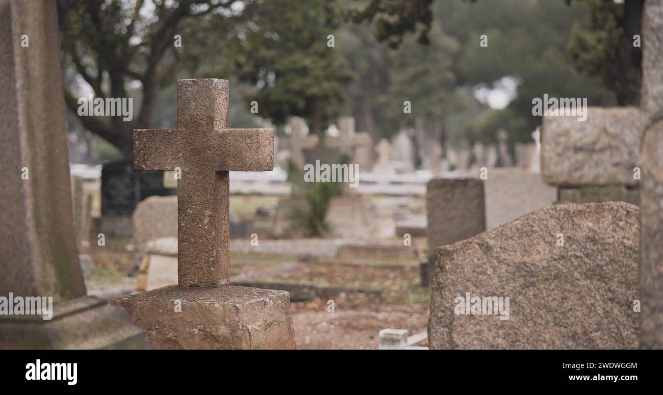 Funeral, cemetery and cross on tombstone for death ceremony, religion ...