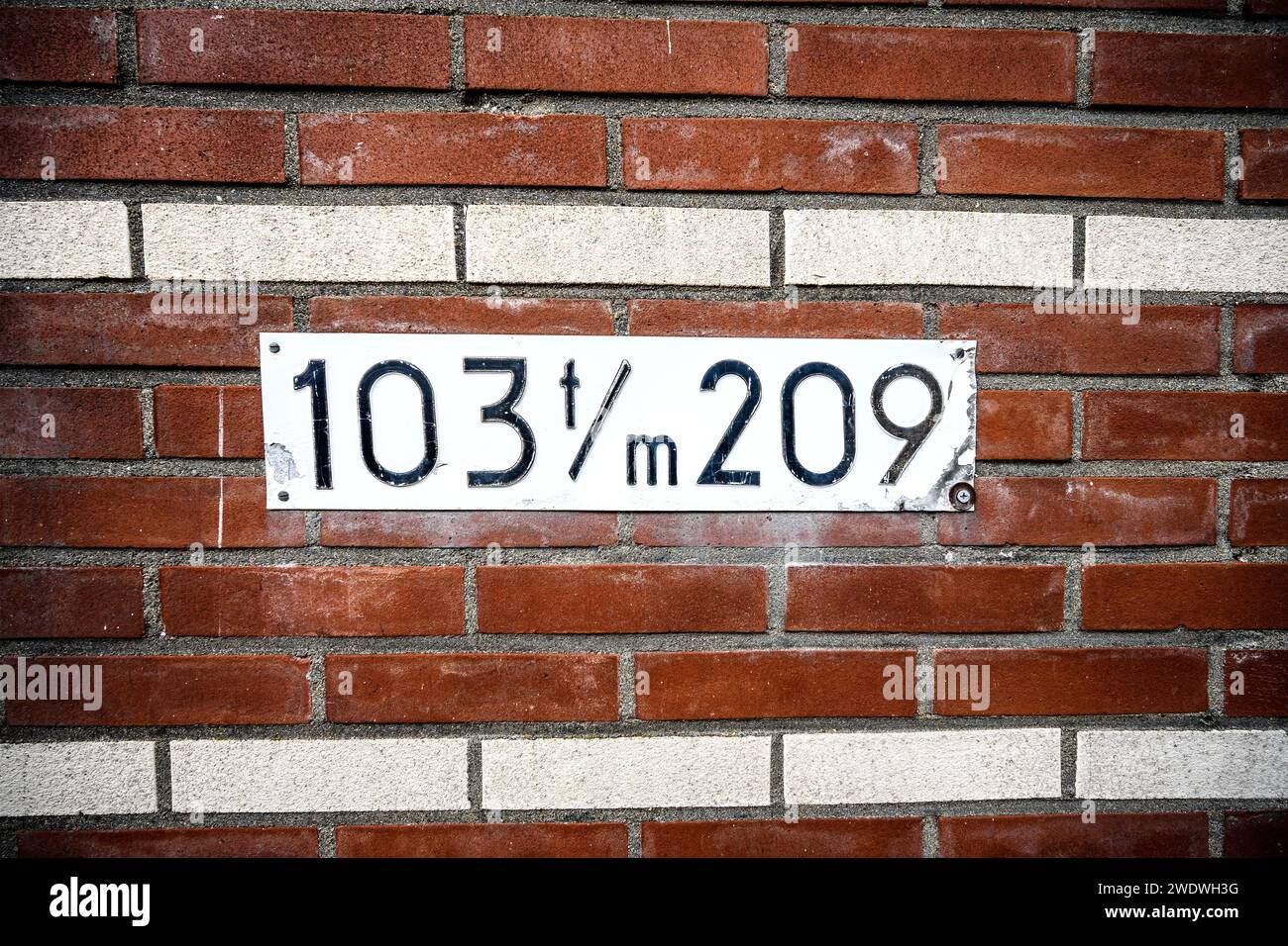 Address sign on residential building brick wall with numbers. House ...