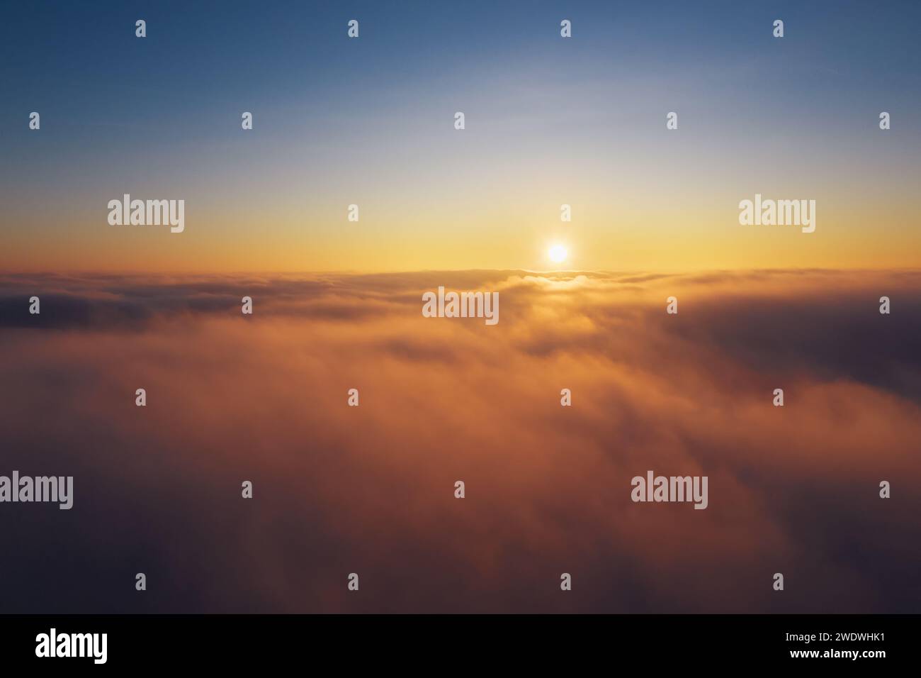 Clear blue sky above the clouds during sunrise. Dramatic cloudscape at ...
