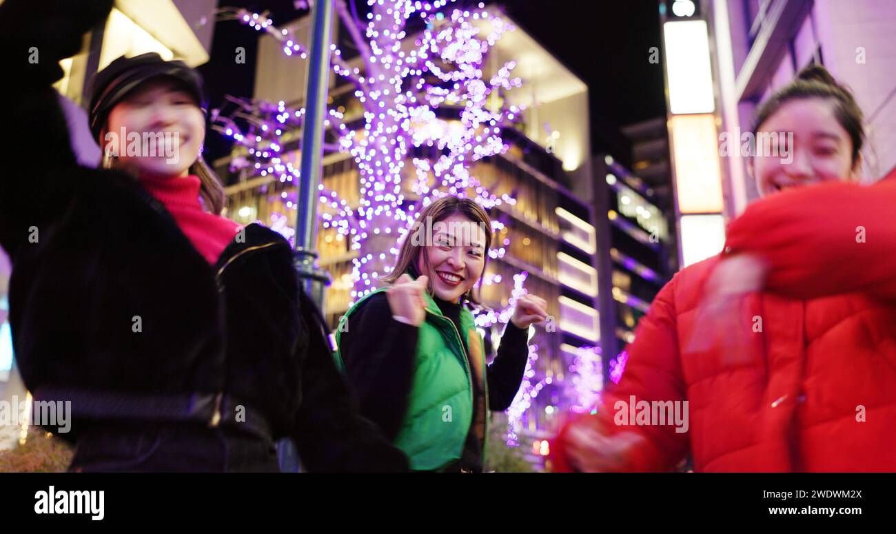 Japanese women at night, dancing in city and fun with energy, happiness ...