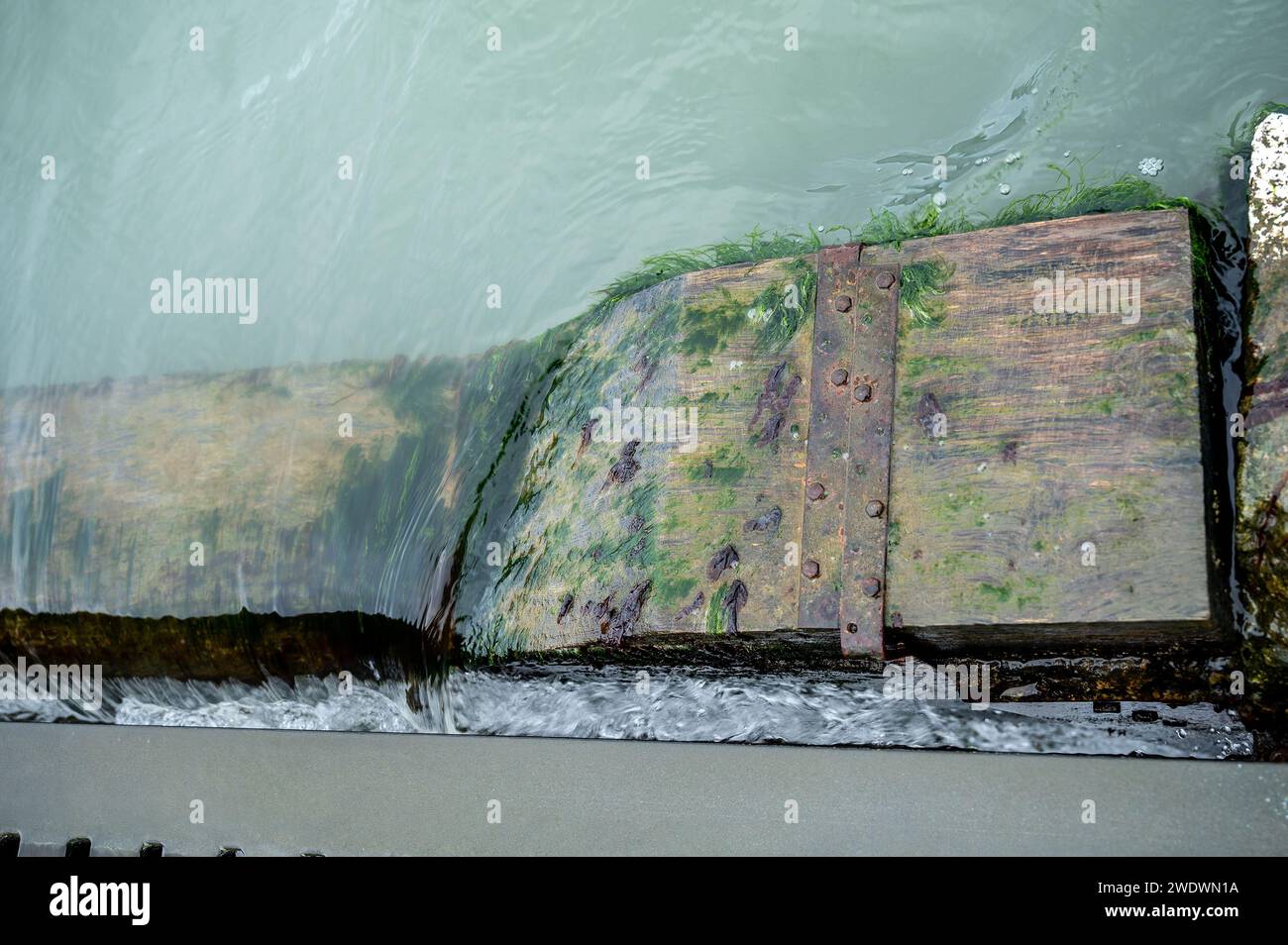 water overflowing old wooden canal barrier Stock Photo - Alamy