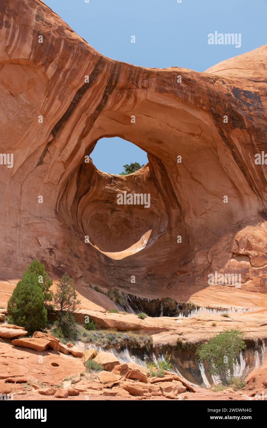 View of Bowtie Arch. Hole in the rock. Blue sky. Corona Arch Trail ...