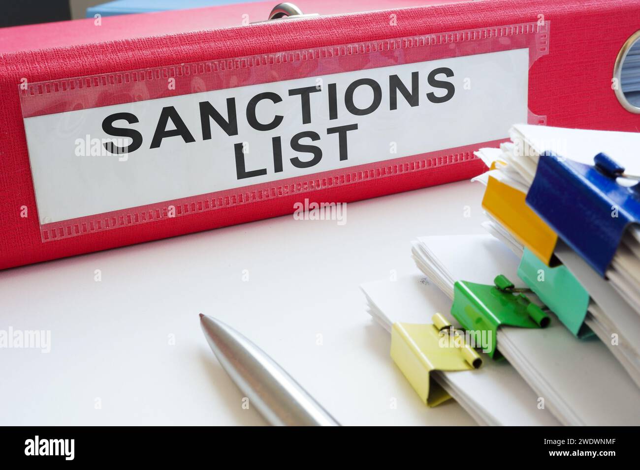 Folder with a label sanctions list and a stack of documents Stock Photo ...
