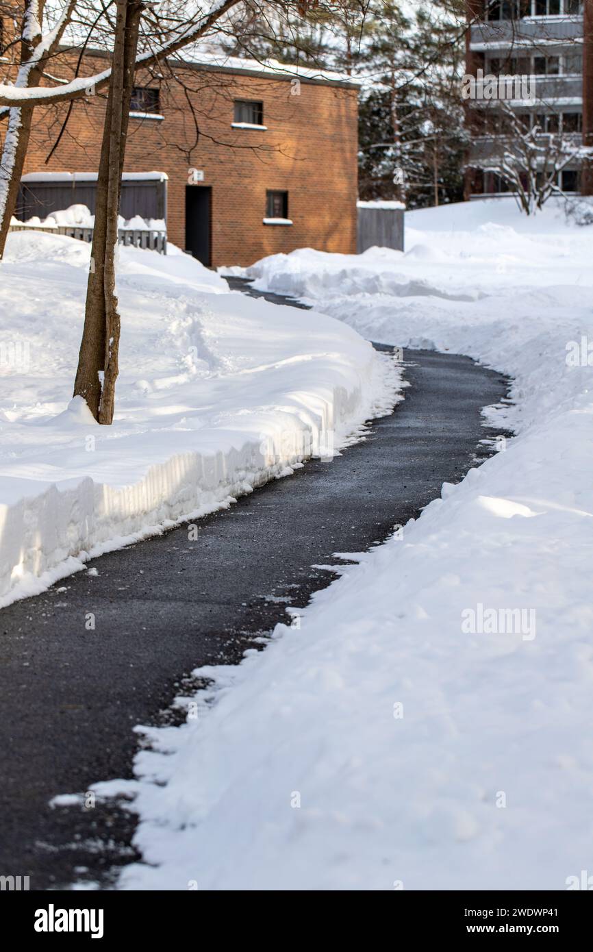 Winter road cleared of snow: Salt used to melt snow on sidewalk near ...