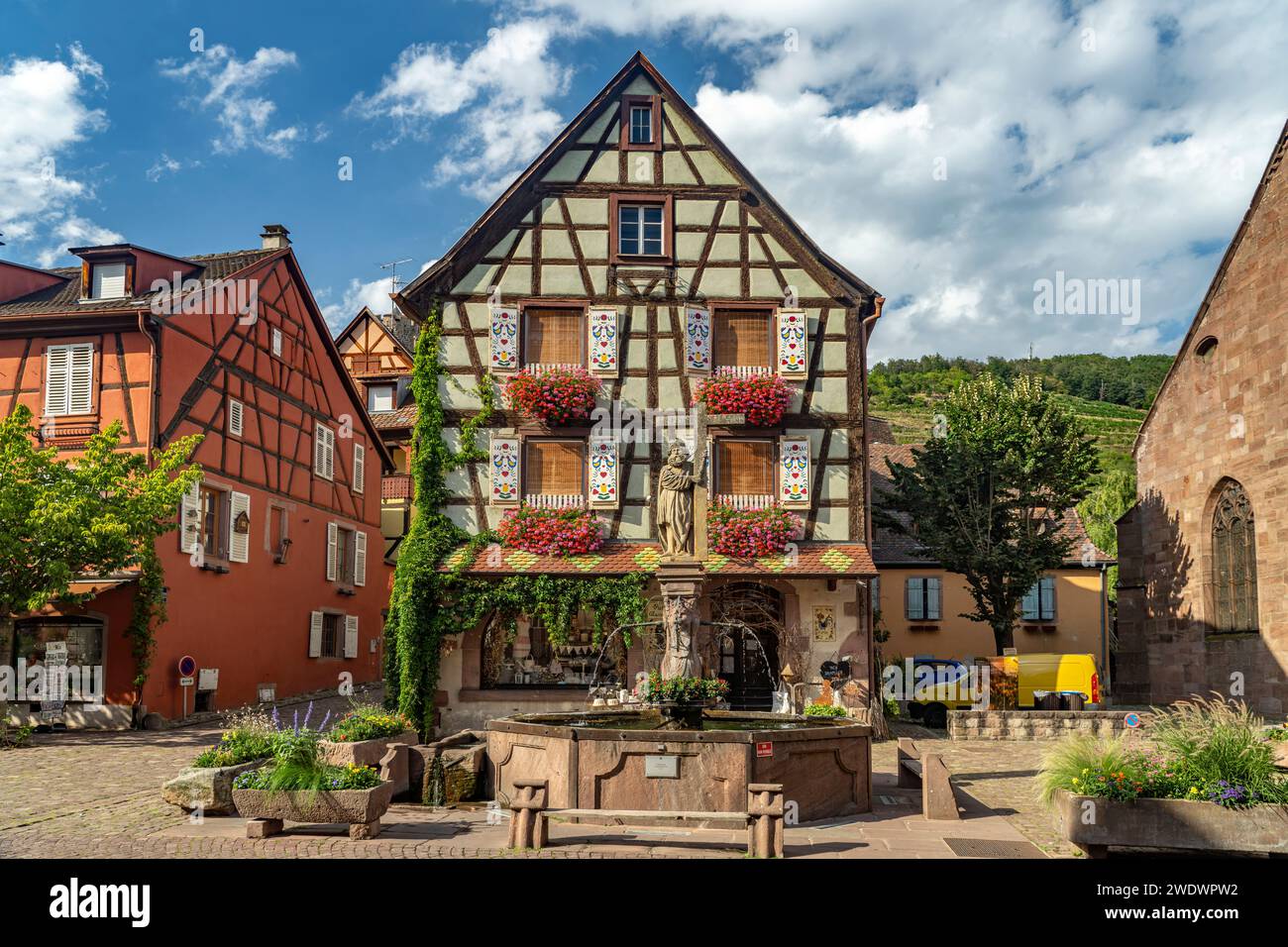 Constantine fountain and half-timbered structure in Kaysersberg, Alsace ...