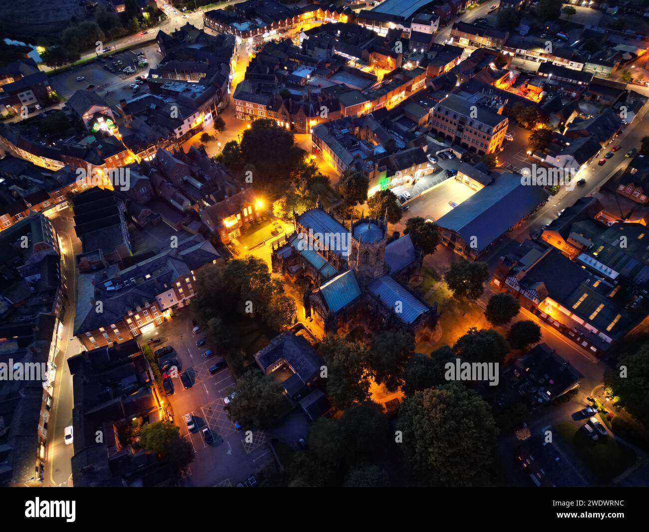 Aerial view of a nocturnal urban scene with a street adjacent to a ...