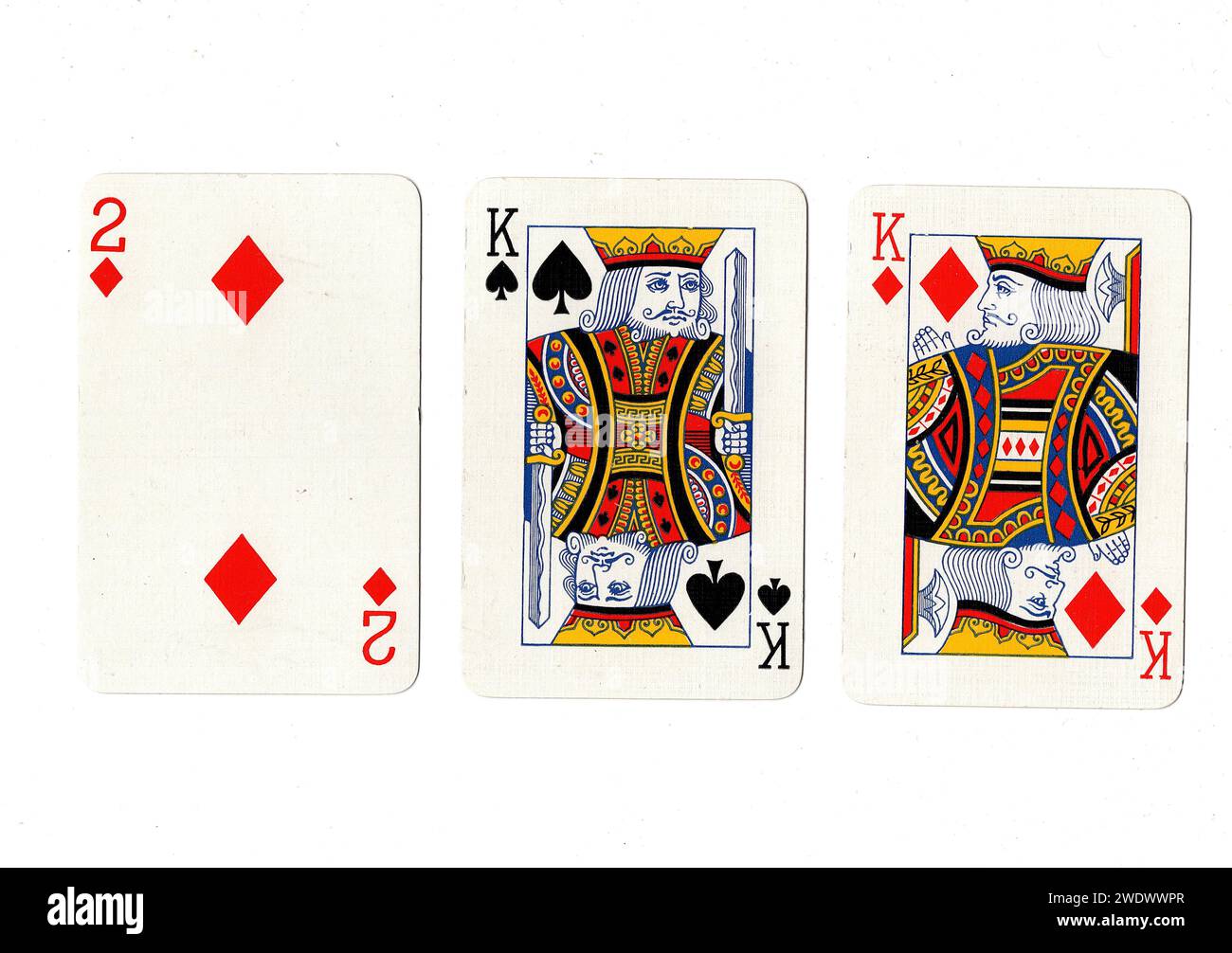 Vintage playing cards showing a pair of kings and a red two isolated on ...
