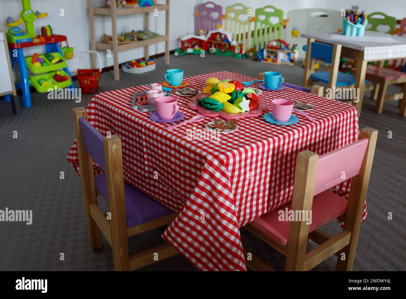 children's space and a table with toys for the kitchen Stock Photo - Alamy