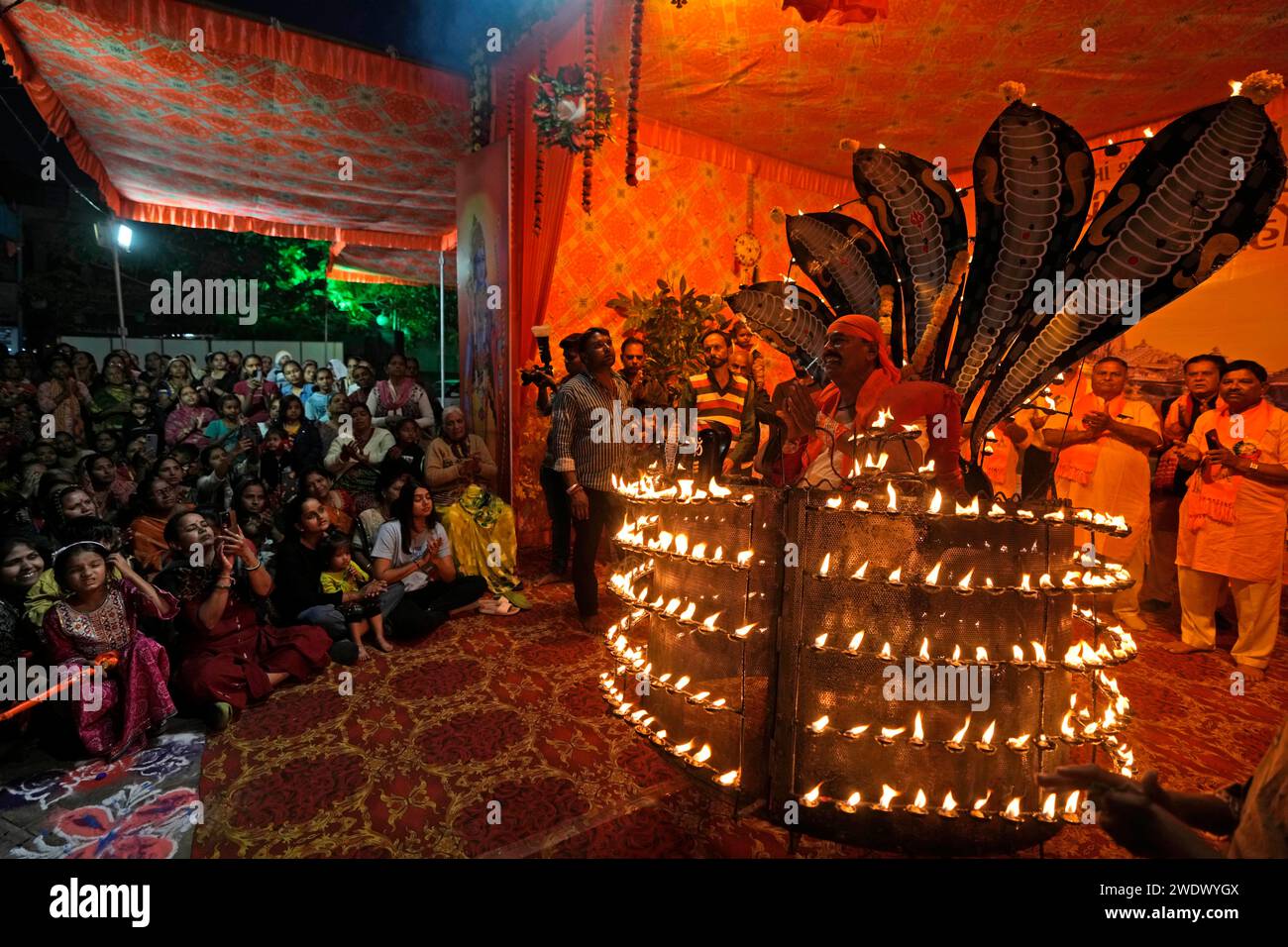 A man performs a ritual during a celebration to mark the grand opening ...