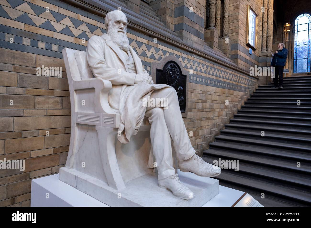 Visitors interact with the statue of English naturalist, geologist and ...