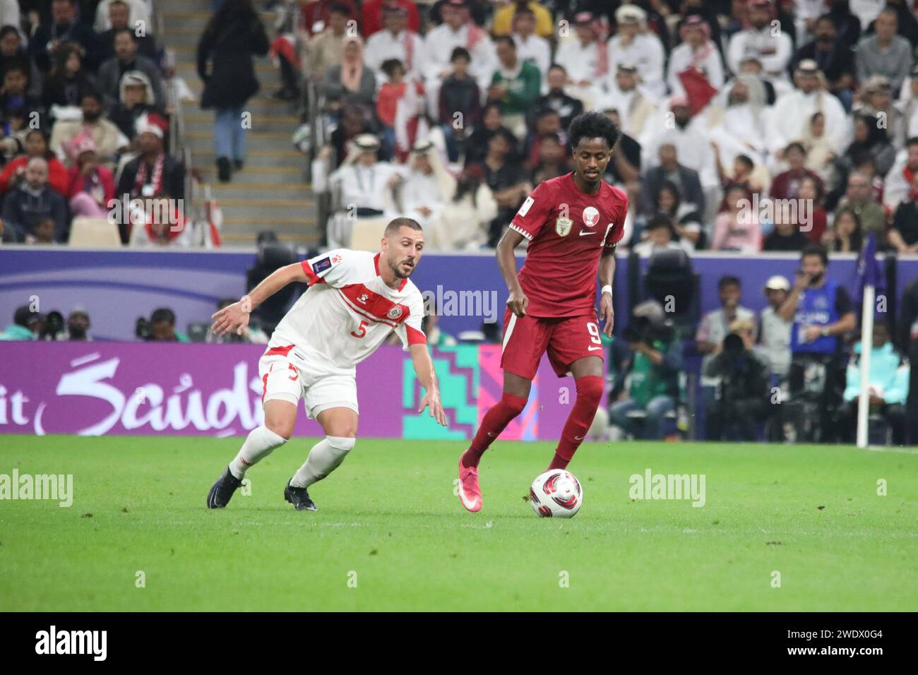 Doha, Qatar. 12th Jan, 2024. Yusuf Abdurisag of Qatar and Nassar Nassar ...