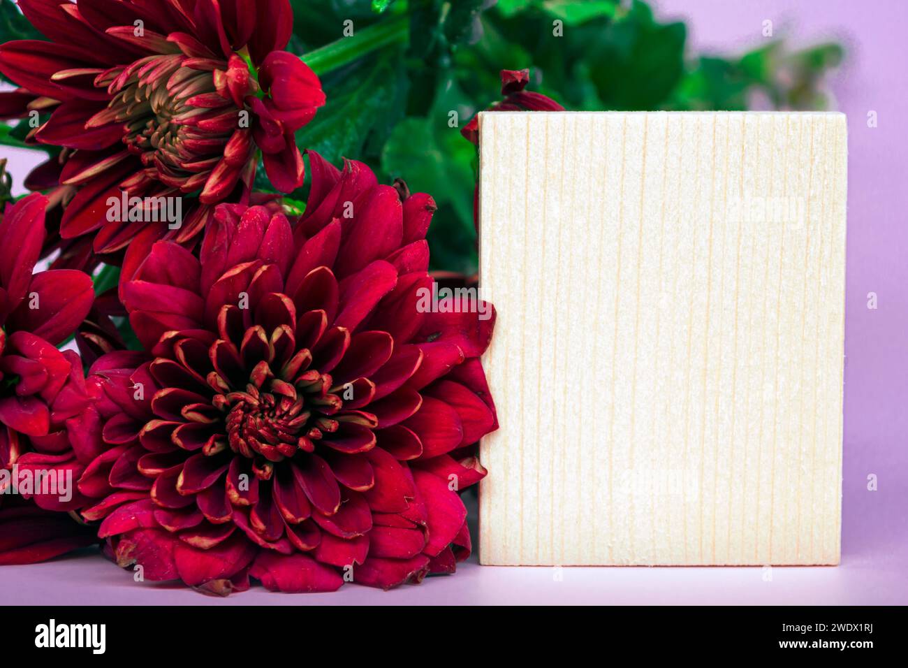 Wooden cube with flower bouquet Stock Photo - Alamy