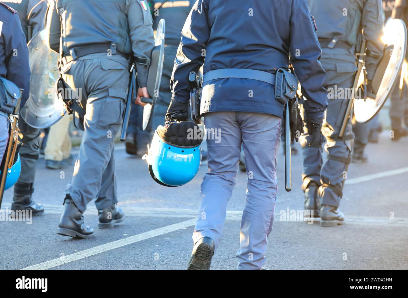 many policemen in uniform with riot gear during the protest ...