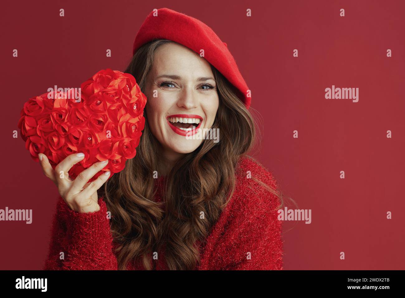 Happy Valentine. smiling elegant 40 years old woman in red sweater and ...