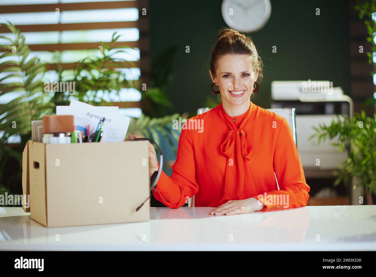 New job. happy modern 40 years old woman employee in modern green ...