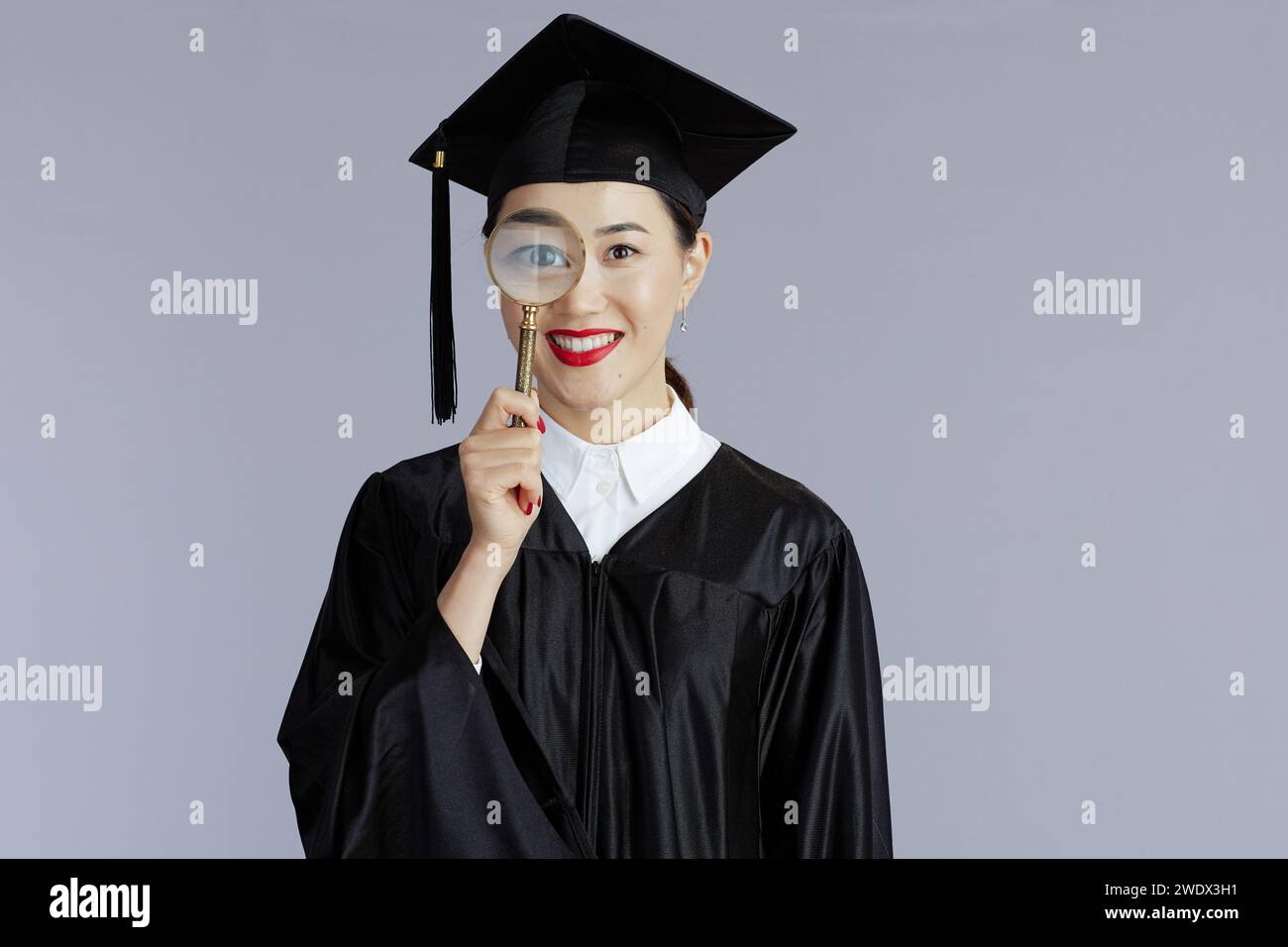 happy modern graduate student asian woman with magnifying glass ...