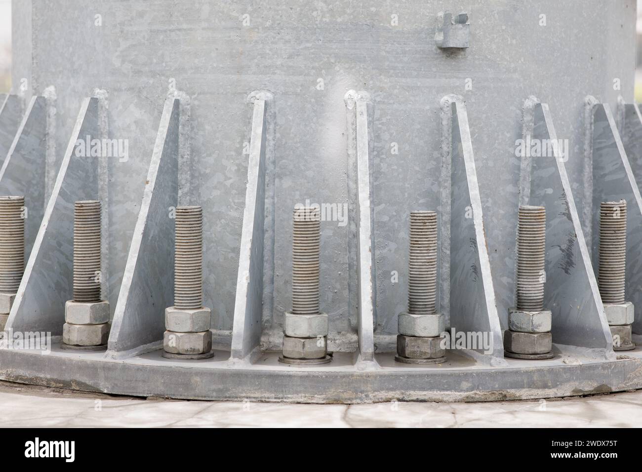 Bolts and nuts on a steel plate. Several bolts are firmly fixed on the ...