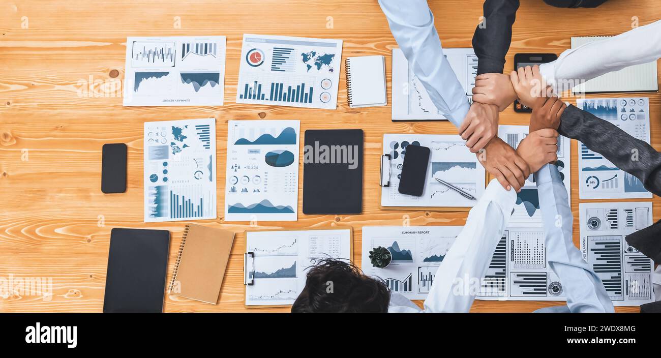Panorama top view shot of diverse team of officer worker hold hand in ...