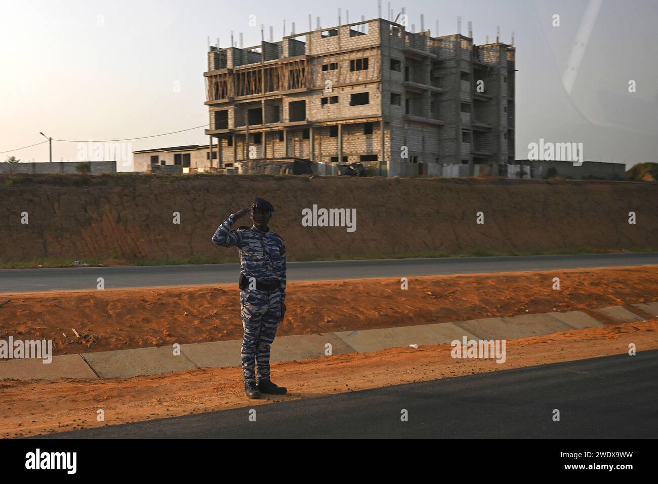 An Ivorian police officer salutes the motorcade of US Secretary of ...