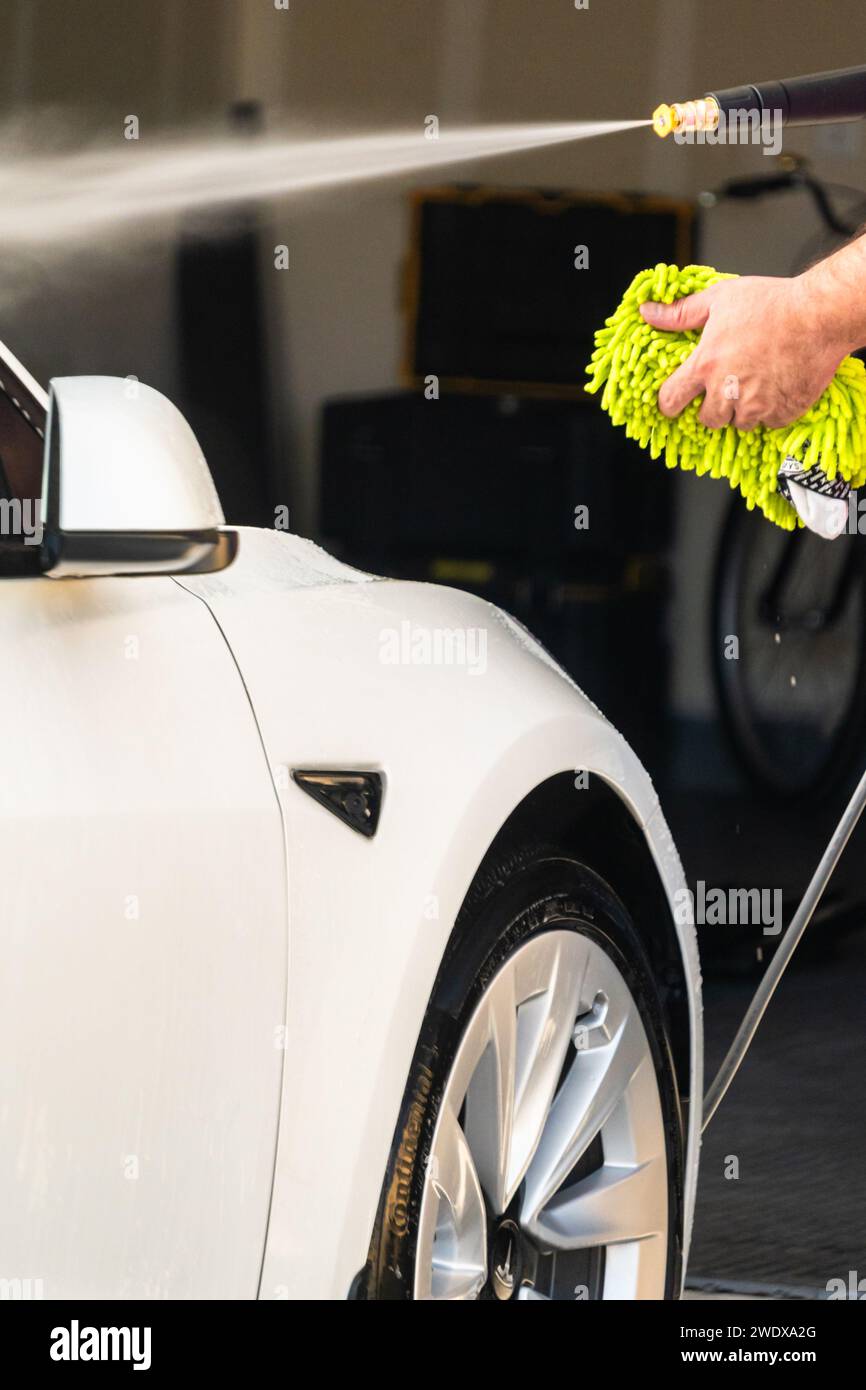 Eco-Friendly Cleaning: Washing an Electric Car at Home Stock Photo - Alamy