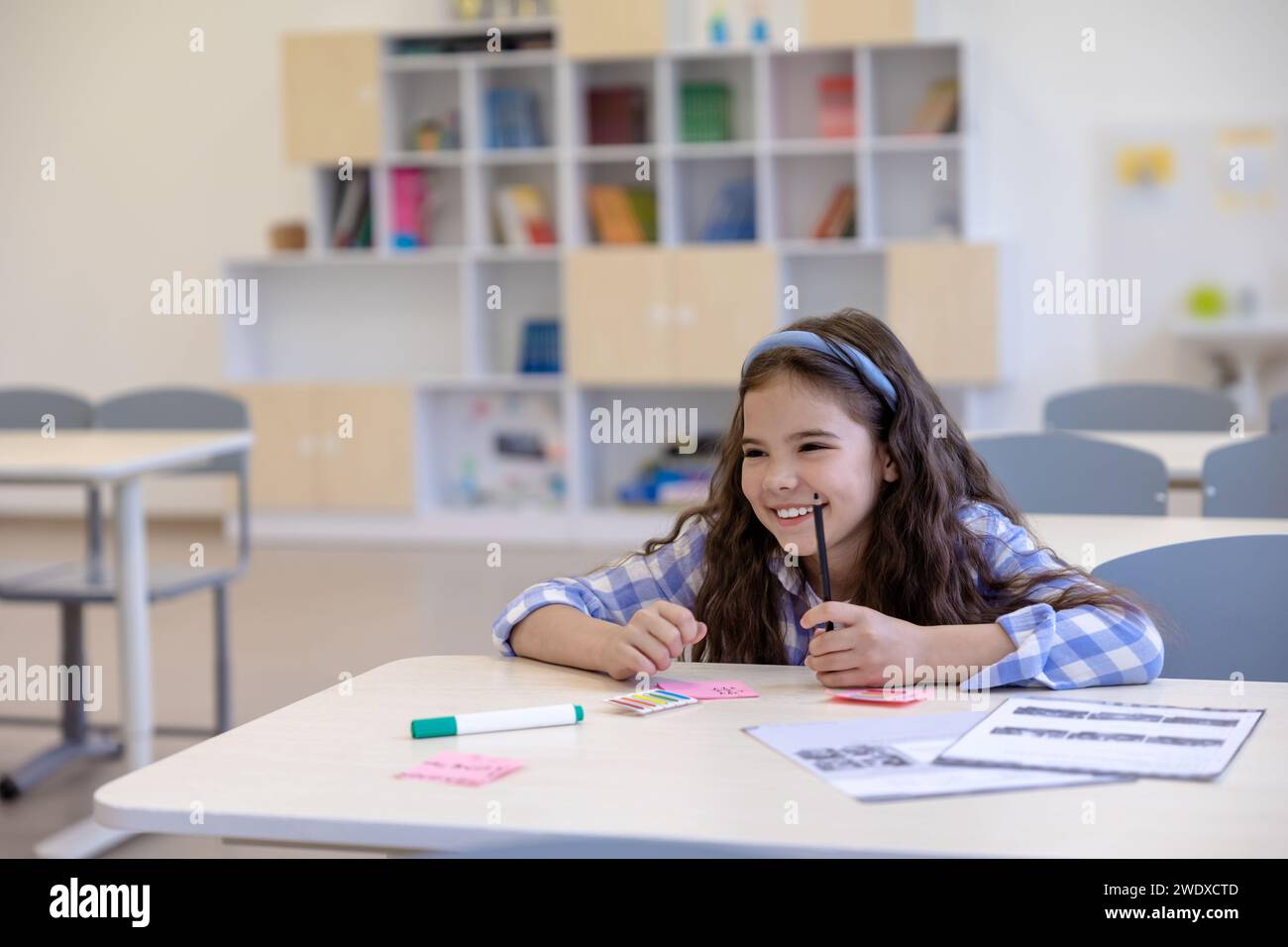 Small girl child sitting at desk little kid handwriting preparing ...