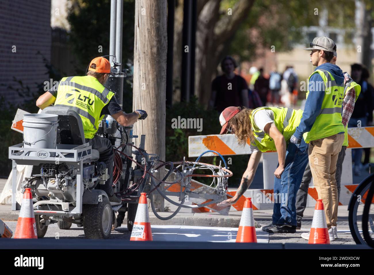 Workers marking crosswalk Stock Photo - Alamy