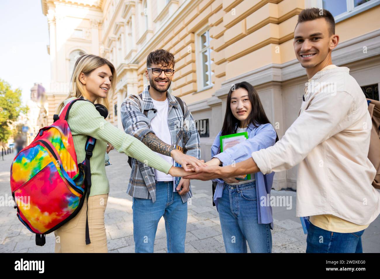 Students holding hands successful teamwork standing in university ...