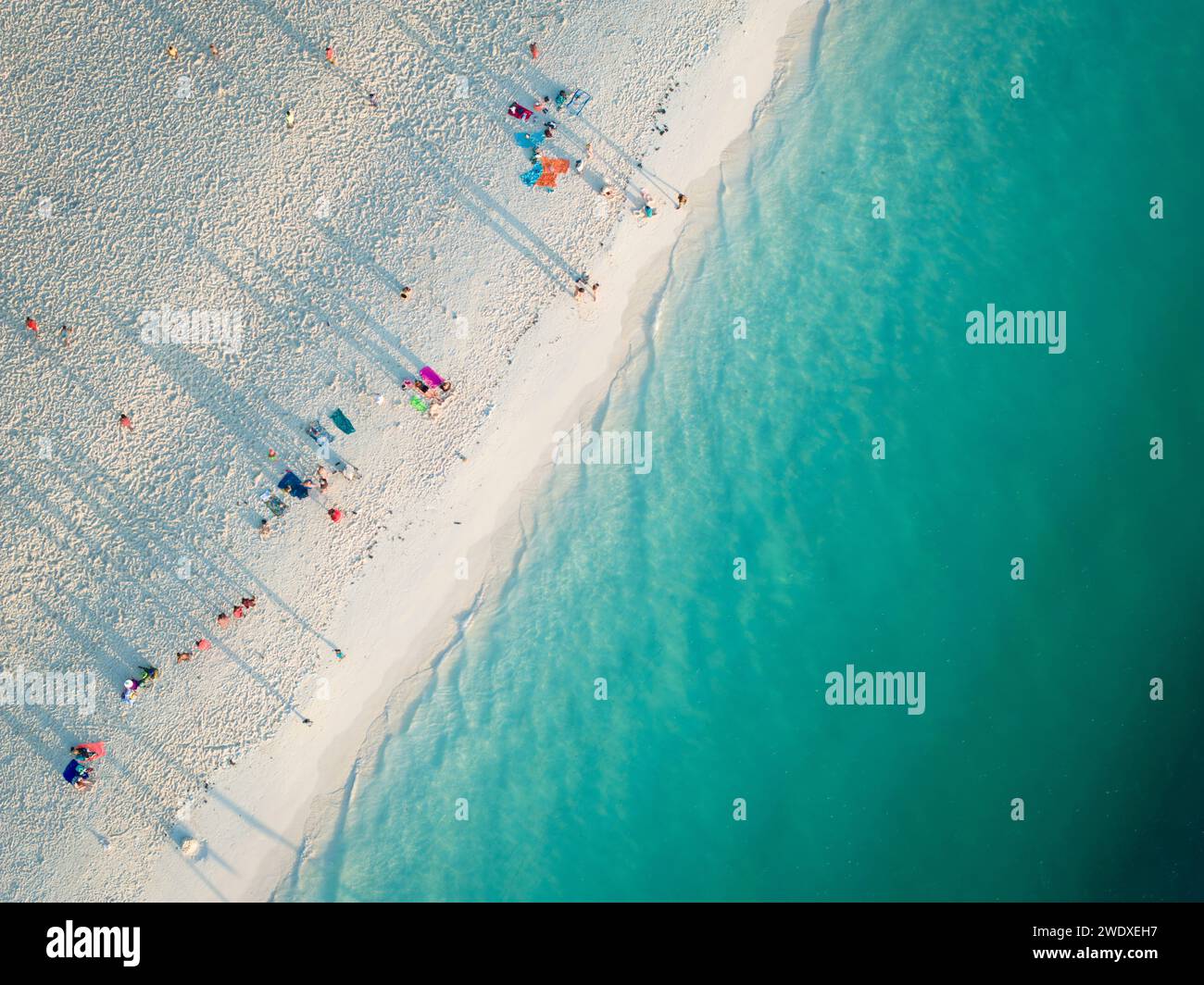 Birds view of boats in the green ocean and wonderful white sandy beach ...