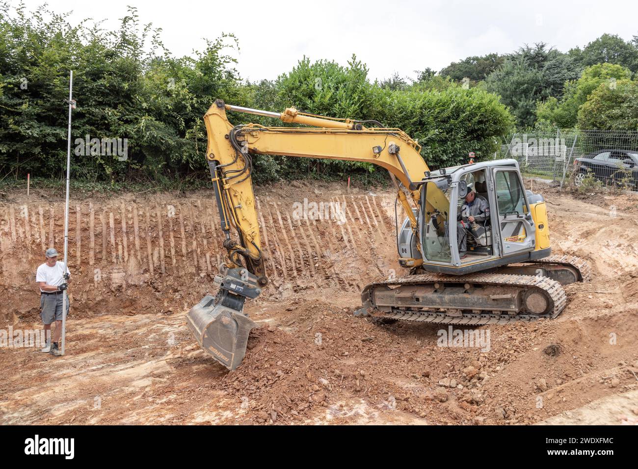 Fischbach, Germany - July 15, 2020: large digger digs a hole for the ...