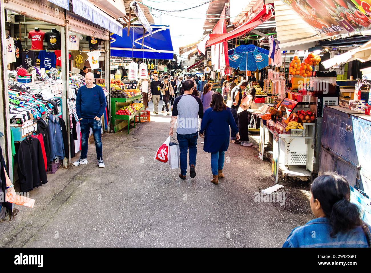 Tel Aviv, Israel - January 22, 2024 People shop at the Carmel market ...
