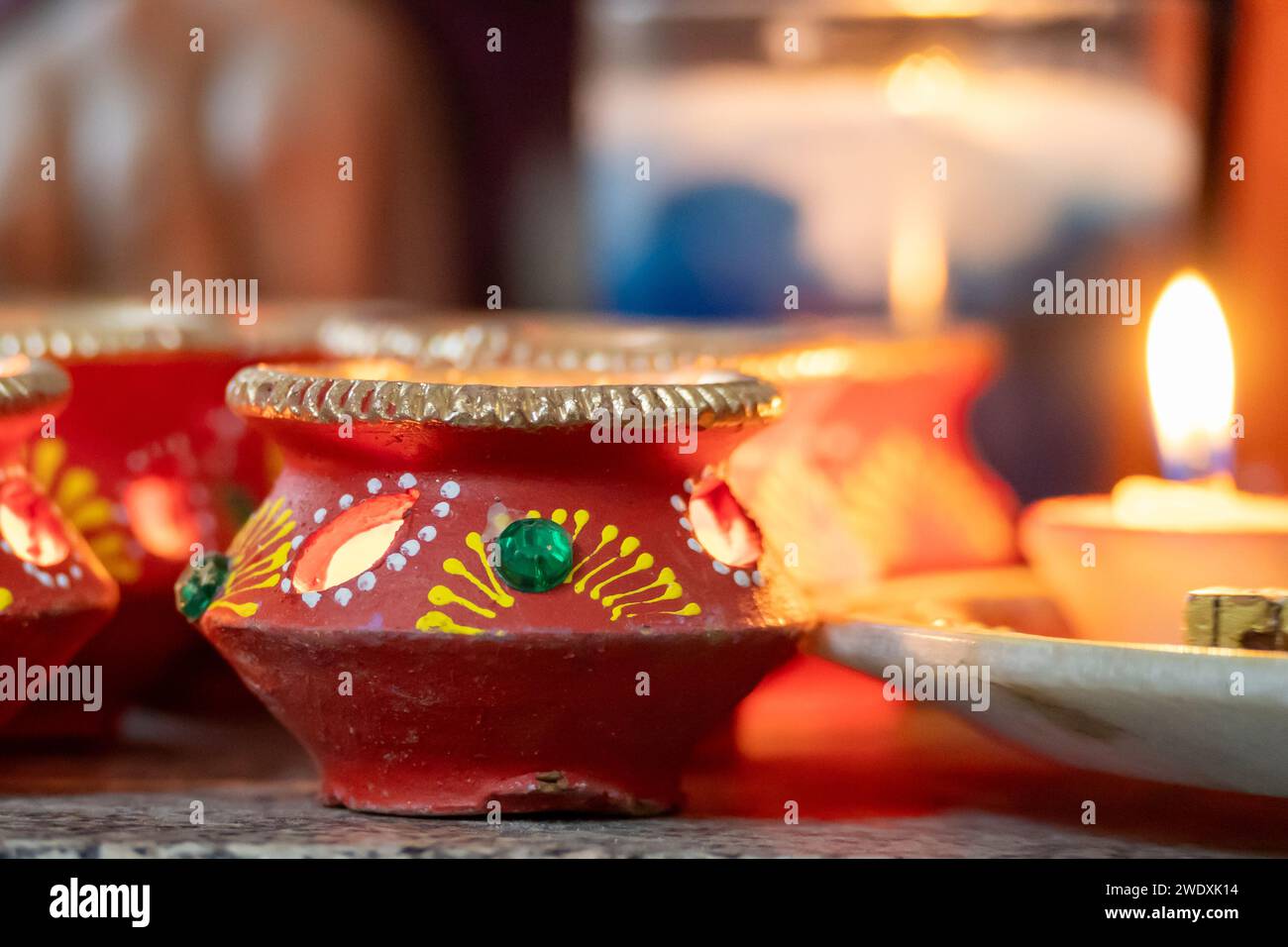 beautifully decorated diyas lit on the eve of diwali and the Ram temple ...