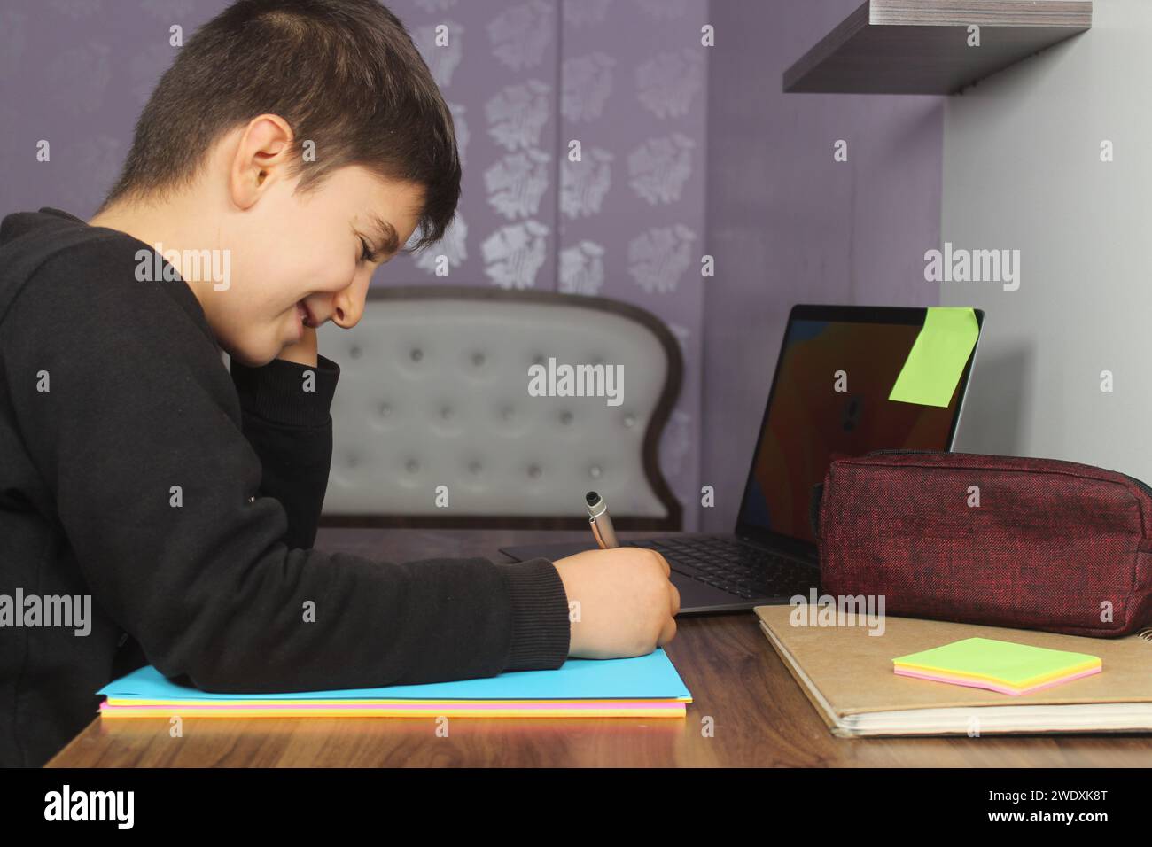 Distance learning online education. A schoolboy boy studies at home and ...