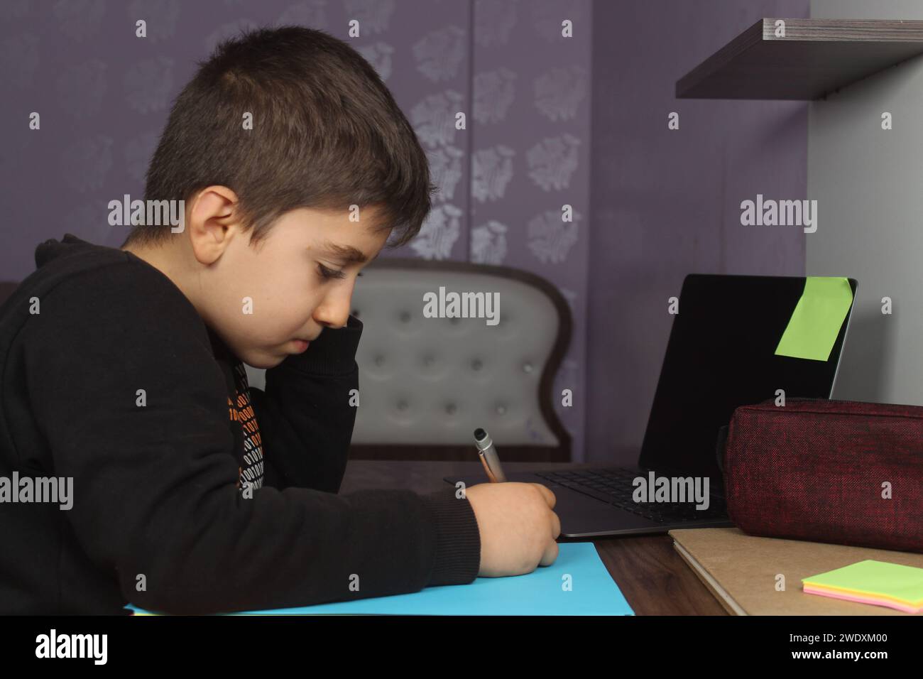 Distance learning online education. Schoolboy boy studies at home and ...