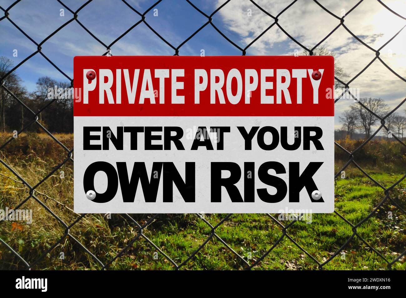 Red an white warning sign on a fence stating in "Private property ...