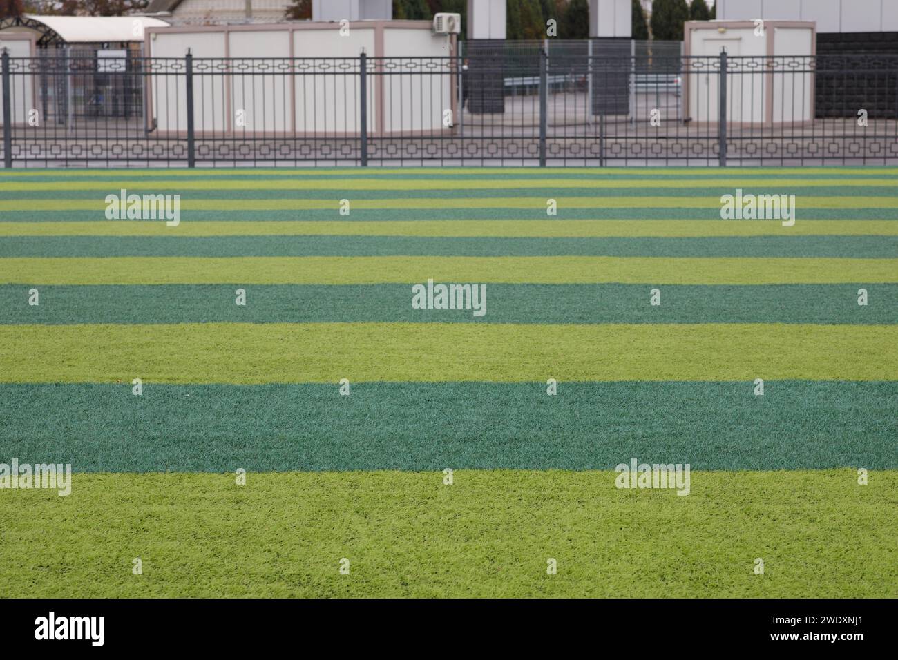 soccer field horizontal green lines, fence background Stock Photo - Alamy