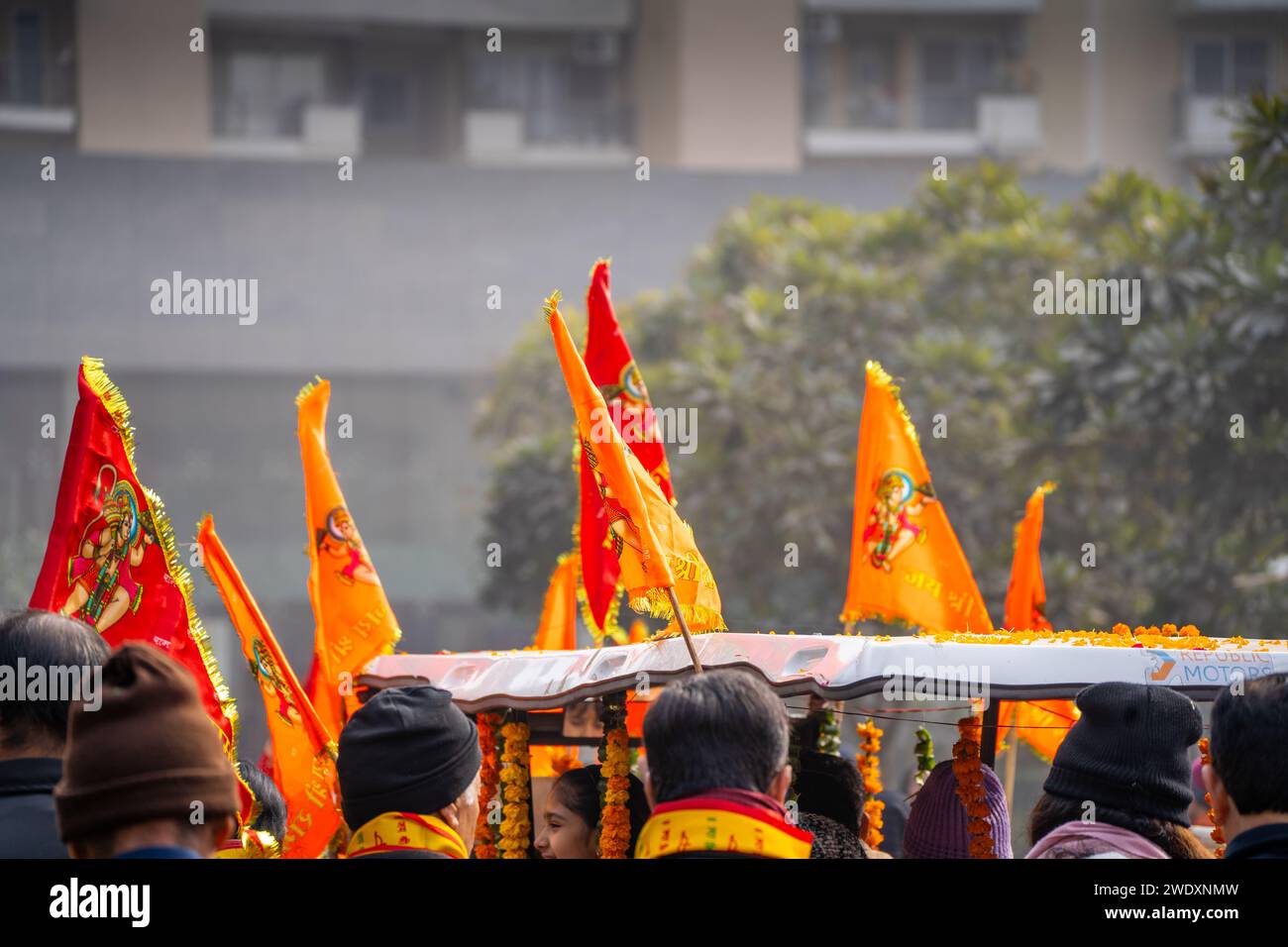 Zoomed in shot showing group of people carrying bhagwa saffron flag ...